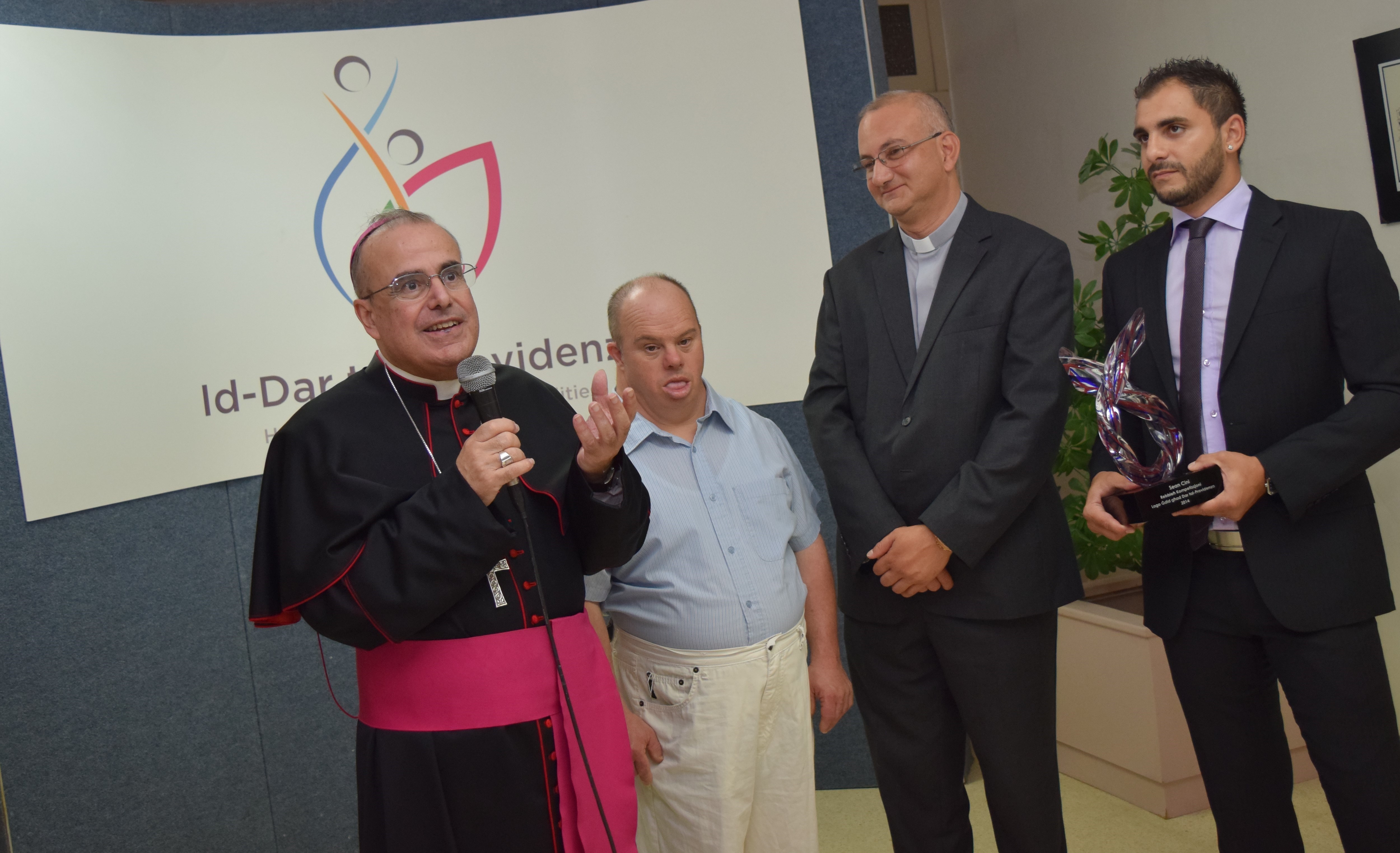 Sean Cini presented with an award for the design of the new logo for ...